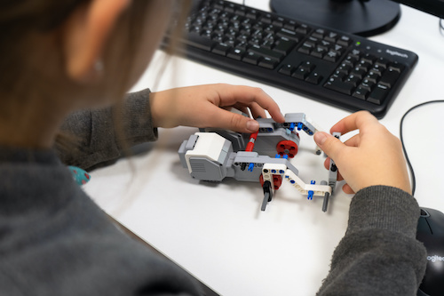 Minsk, Belarus. October, 2019. Boys and girls construct and code robots. Lego Mindstorms EV 3 ...